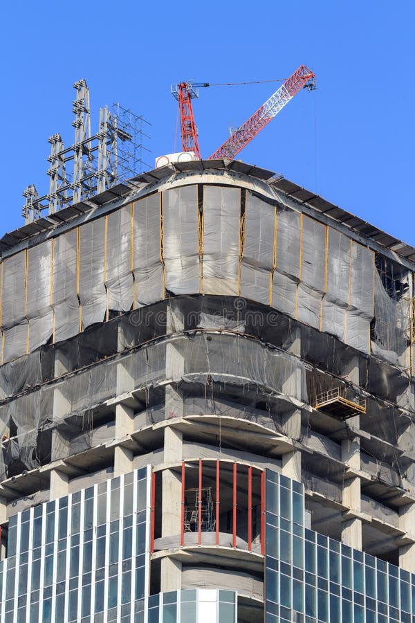 Cranes on Top of Under Construction High-rise Building Stock Image ...