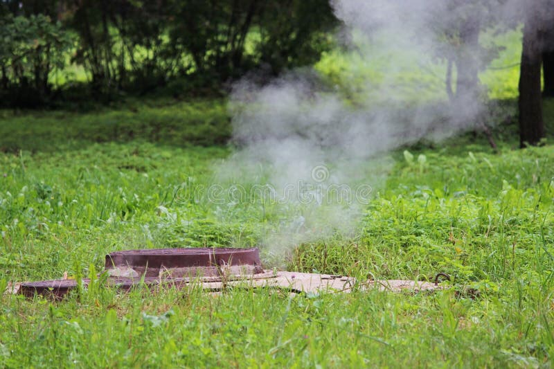 Crash Pipe Hot Water Under the Hatch. Steam and Green Grass Stock Image ...