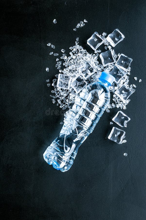 Crashed Ice Cubes with Bottle on Black Kitchen Table Top View Mock Up ...