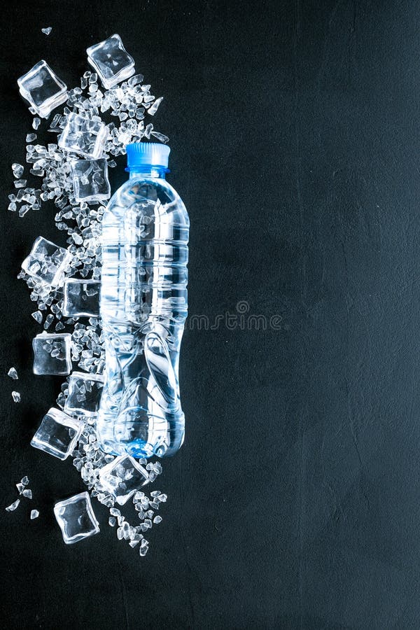 Crashed Ice Cubes with Bottle on Black Kitchen Table Top View Mock Up ...