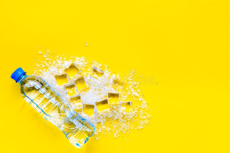 Crashed Ice Cubes with Bottle on Yellow Kitchen Table Top View Mock Up ...