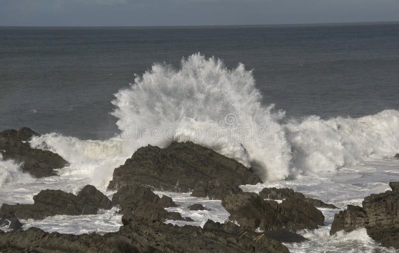 Crashing wave on rocks. stock photo. Image of tide, rocks - 18431842