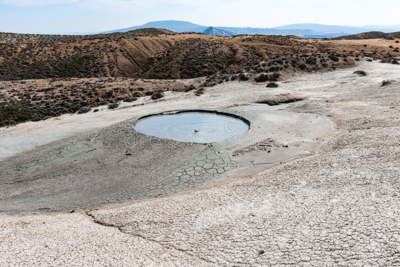 Crater of a mud volcano stock photo. Image of arid, desert - 69600406