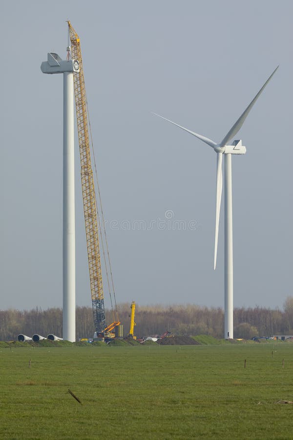 A Crawler Crane is Hoisting the Nacelle of a New Wind Turbine Stock ...