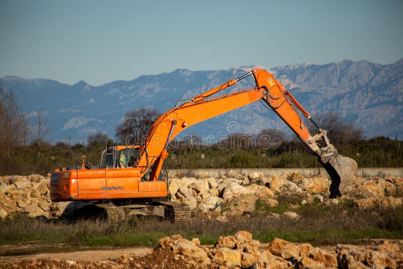 Crawler Excavator Clearing Piles of Rocks. Orange Color Machine Stock ...
