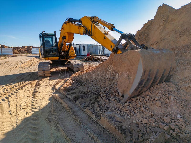 Crawler Excavator Machine Unloading Sand or Soil at Construction Area ...