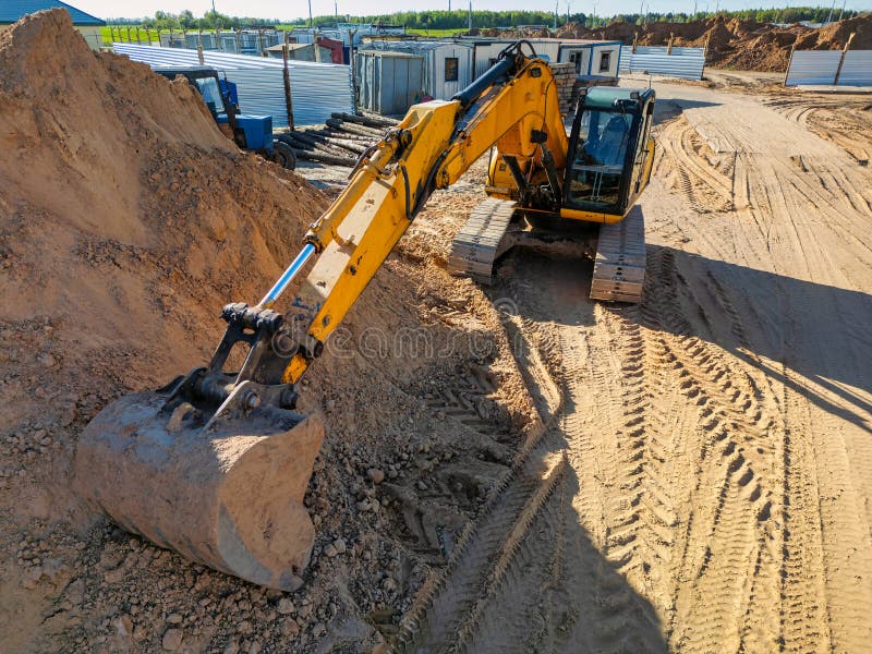 Crawler Excavator Machine Unloading Sand or Soil at Construction Area ...