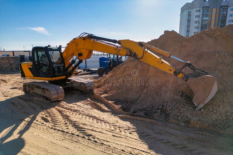Crawler Excavator Machine Unloading Sand or Soil at Construction Area ...