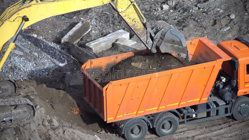 Video: Crawler excavator working and load into dumper truck at the ...