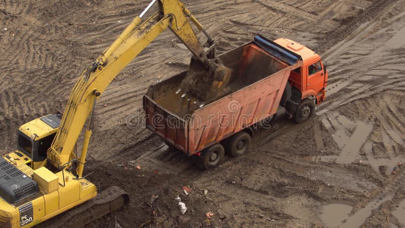 Video: Crawler excavator working and load into dumper truck at the ...