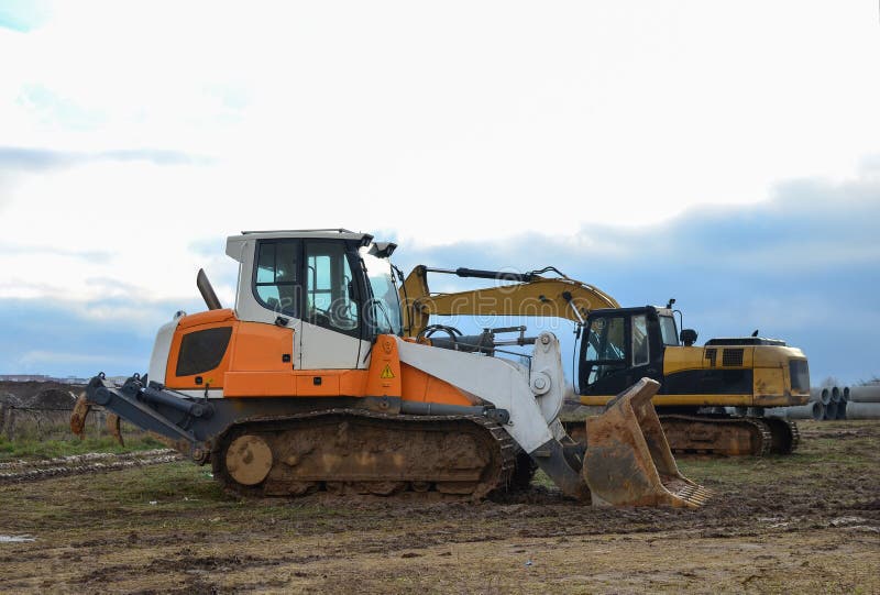 Crawler Loader and Excavator at Construction Site. Stock Photo - Image ...
