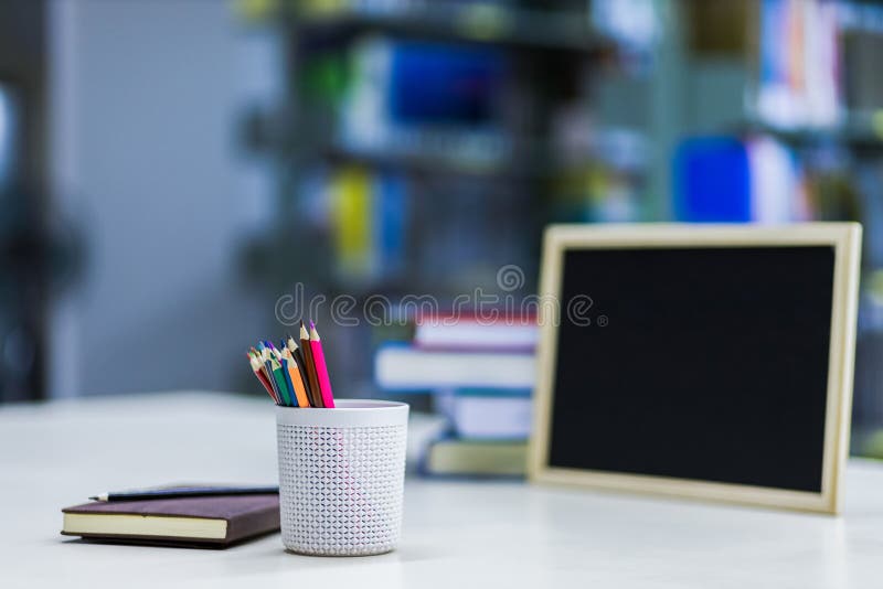Crayon in Pencil Case Near Book and Black Board on the Table Stock ...
