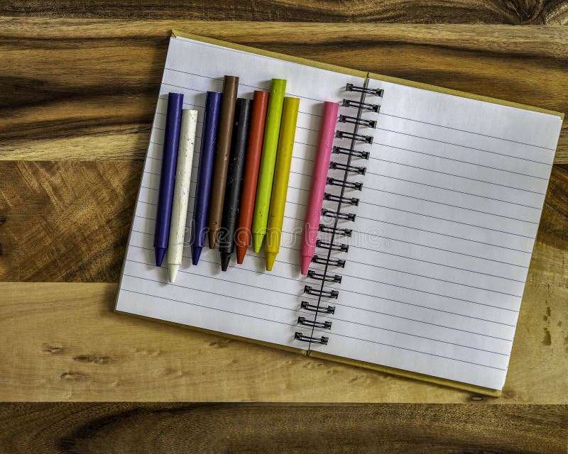 Crayons on a notebook stock image. Image of woodgrain - 138162187