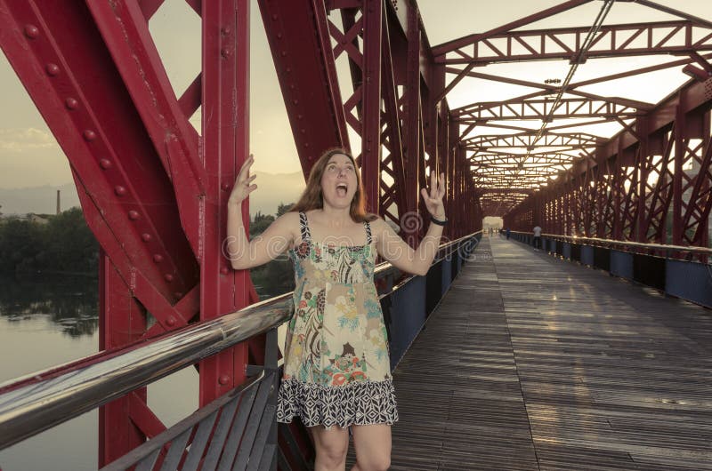 Crazy Beautiful Woman Screaming on the Red Bridge Over. Stock Image ...