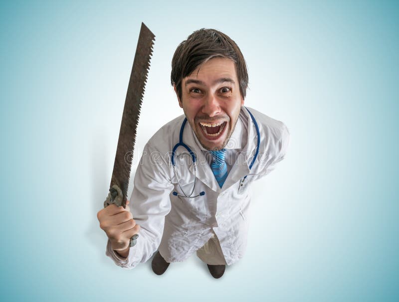 Funny and Crazy Doctor is Laughing and Holds Saw in Hand on Whit Stock ...
