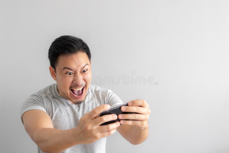Crazy and Funny Face of Man Addicted To Mobile Game. Stock Image ...
