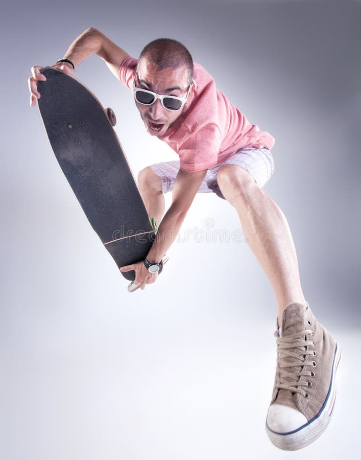 Crazy Guy Jumping with a Skateboard Making Funny Faces Stock Photo ...