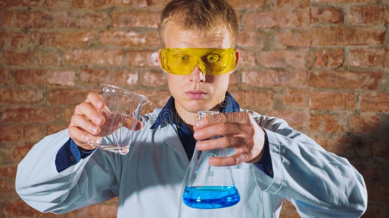 Crazy, Mad Scientist Conducting a Chemical Experiment in Laboratory ...