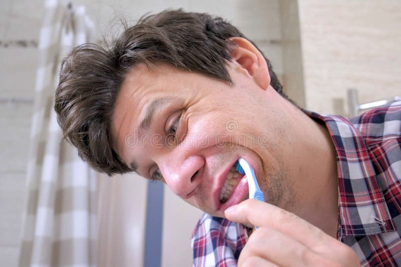 Crazy Young Man Cleans His Teeth in the Bathroom. Stock Image - Image ...