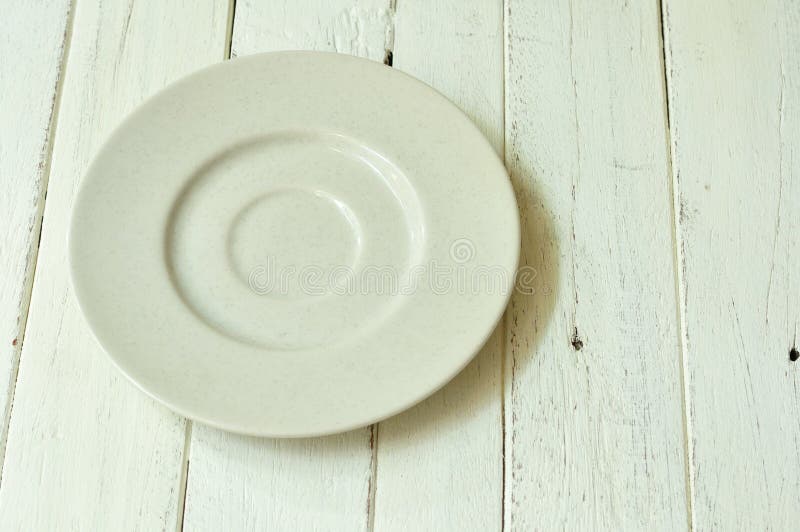 Cream Color Ceramic Plate on Wooden Floor Stock Image - Image of circle ...