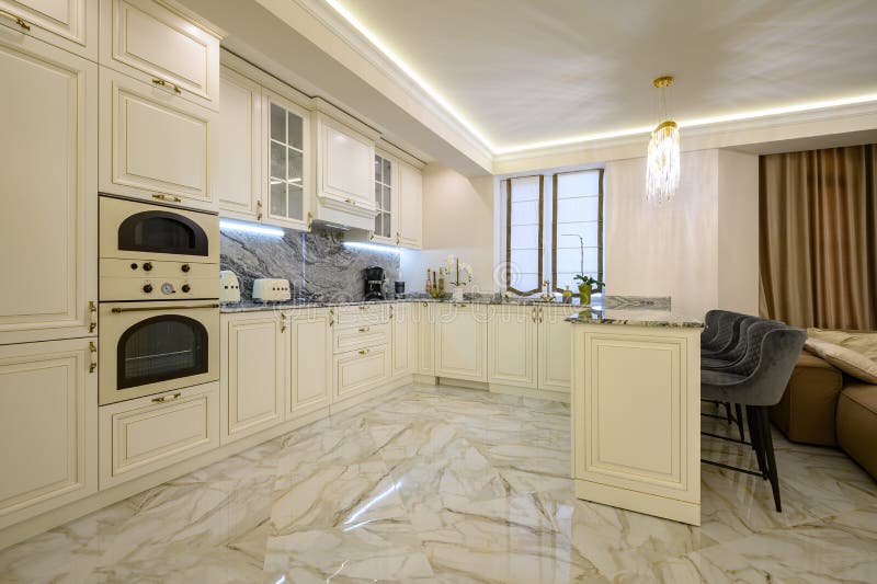 Cream-colored Classic Kitchen with Island Serving As Dining Area in ...