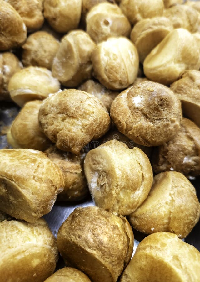 Cream filled profiteroles stock photo. Image of brown - 371975130