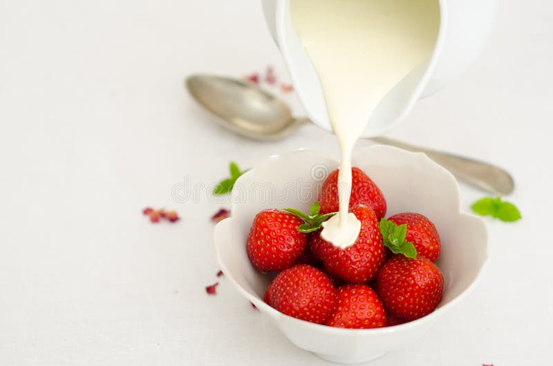Cream Pouring from a Jug Over Fresh Strawberries Stock Image - Image of ...