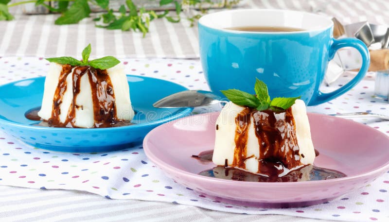 Cream Pudding with Chocolate Sauce, Mint and Cup of Tea on Multi Stock ...