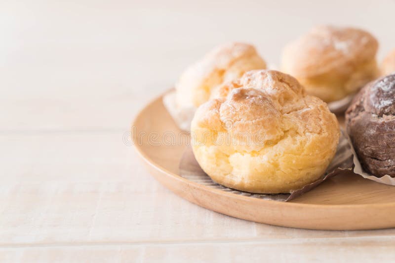Cream puff on plate stock photo. Image of choux, filled - 96675572