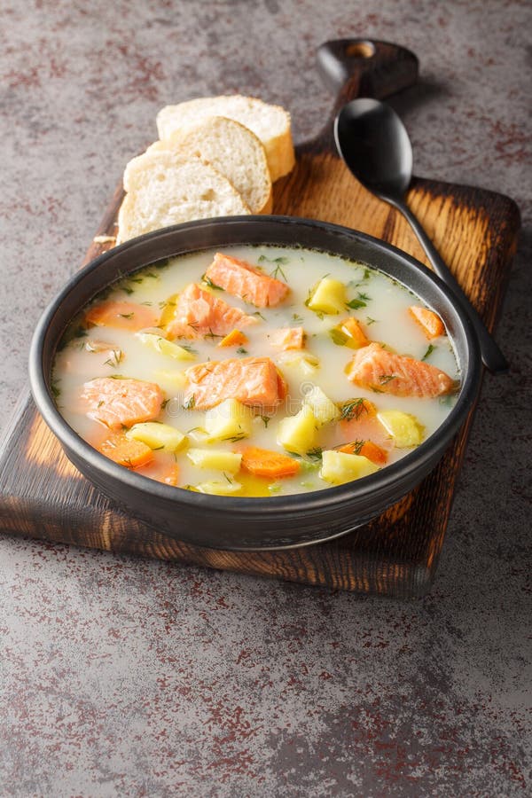 Creamy Red Fish Soup with Vegetables on a Plate Served with Bread Close ...
