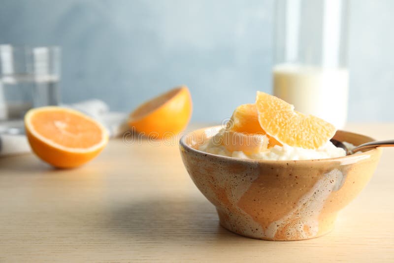 Creamy Rice Pudding with Orange Slices in Bowl on Wooden Table Stock ...