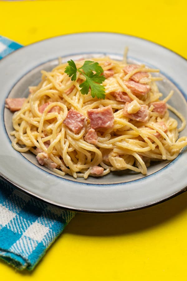 Creamy Spaghetti Pasta with Ham on Yellow Background Stock Photo ...