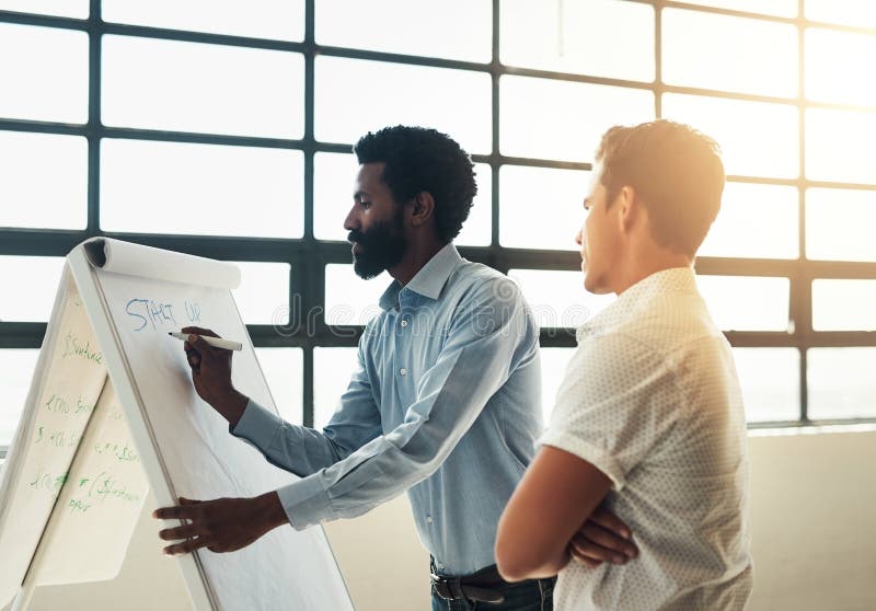 Creating Concepts that Work. Two Businessmen Brainstorming Together in ...