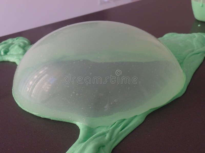 Creating a Large Bubble from Bright Green Slime Stock Image - Image of ...