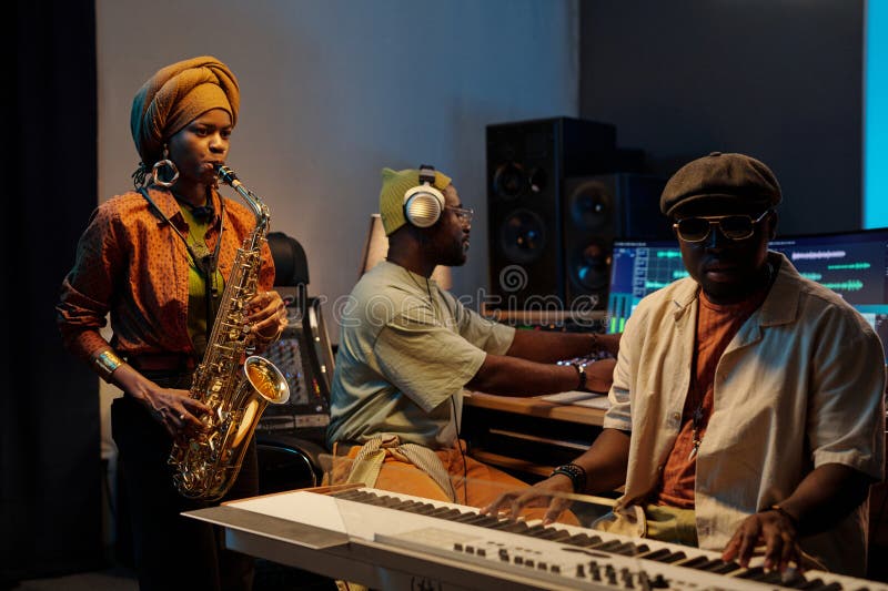 Creating Music in Recording Studio with Saxophone and Keyboard Stock ...