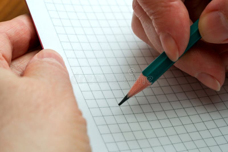 Creating Precise Designs on Grid Paper with Focused Hands Stock Photo ...
