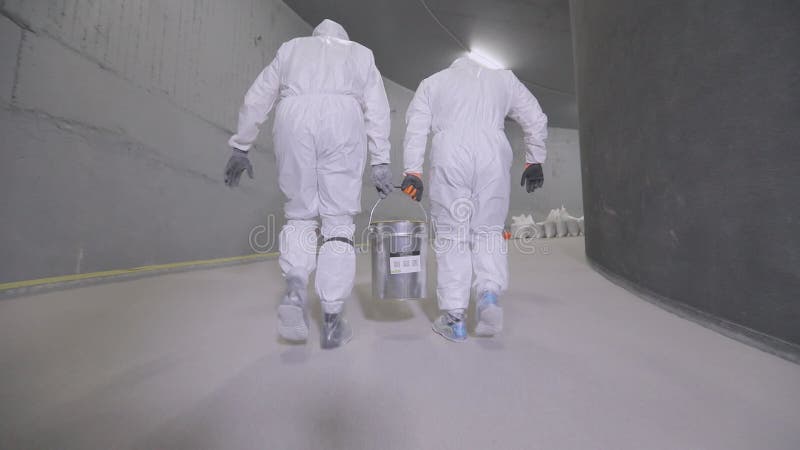 Builders Carry a Bucket of Mortar. Work on the Construction Site ...