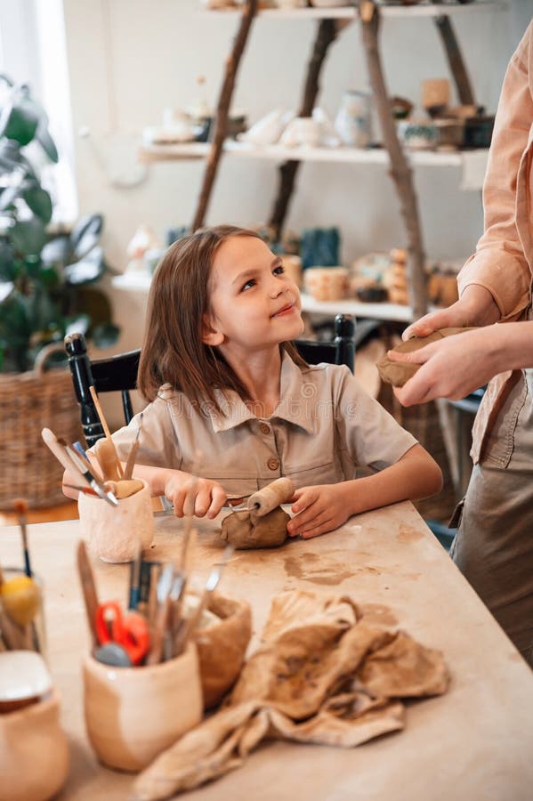 Creating the Shape by Using Clay. Mother with Little Girl Doing Pottery ...