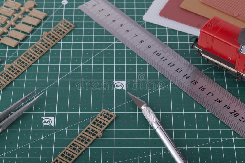 Creating Train Layout with Tools on Cutting Mat Stock Image - Image of ...