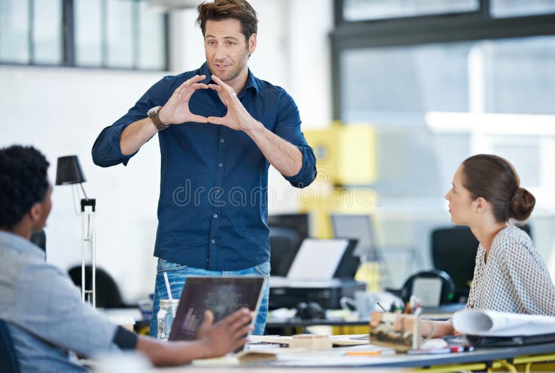 Creating Workplace Synergy. a Group of Young Designers Working Together ...