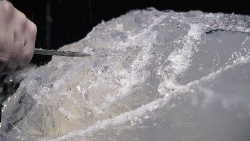 Close Up of Pieces of Ice Being Broken Off with a Chisel, Artist ...