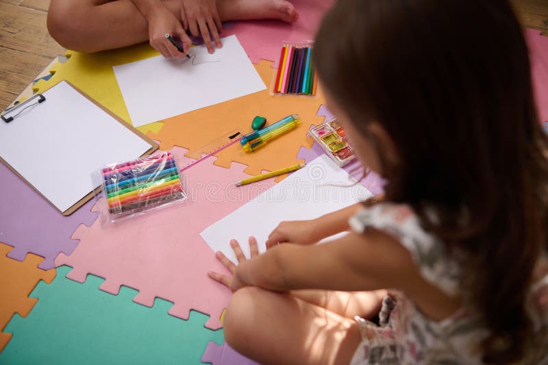 Children Creating Art Together on Colorful Puzzle Mats with Drawing ...