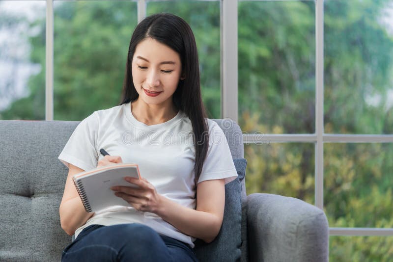 Creative Woman is Writing Memory Planning and Idea on To a Notebook on ...