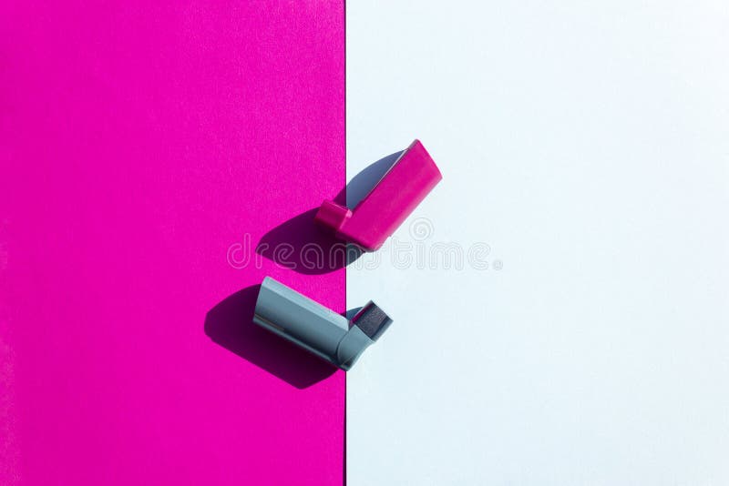 Creative Asthma Concept. Blue and Pink Asthma Inhalers on a Blue and ...