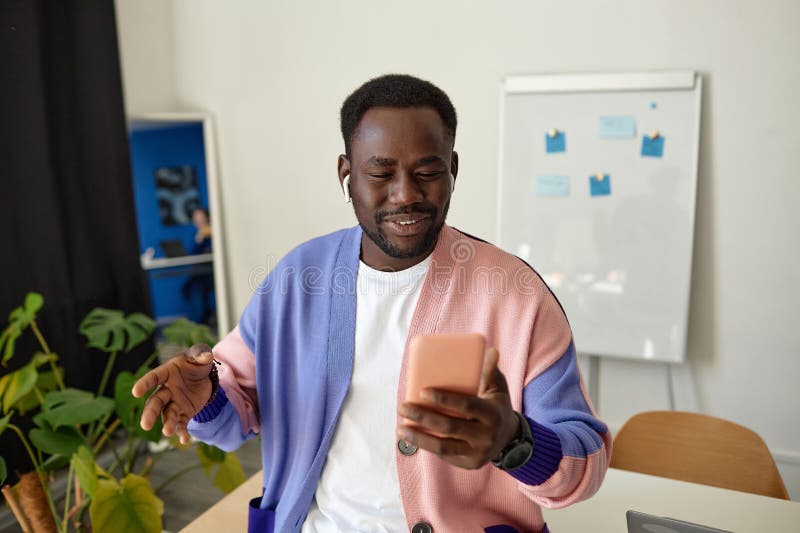 Creative Black Man Using Smartphone with Videochat in Office Stock ...