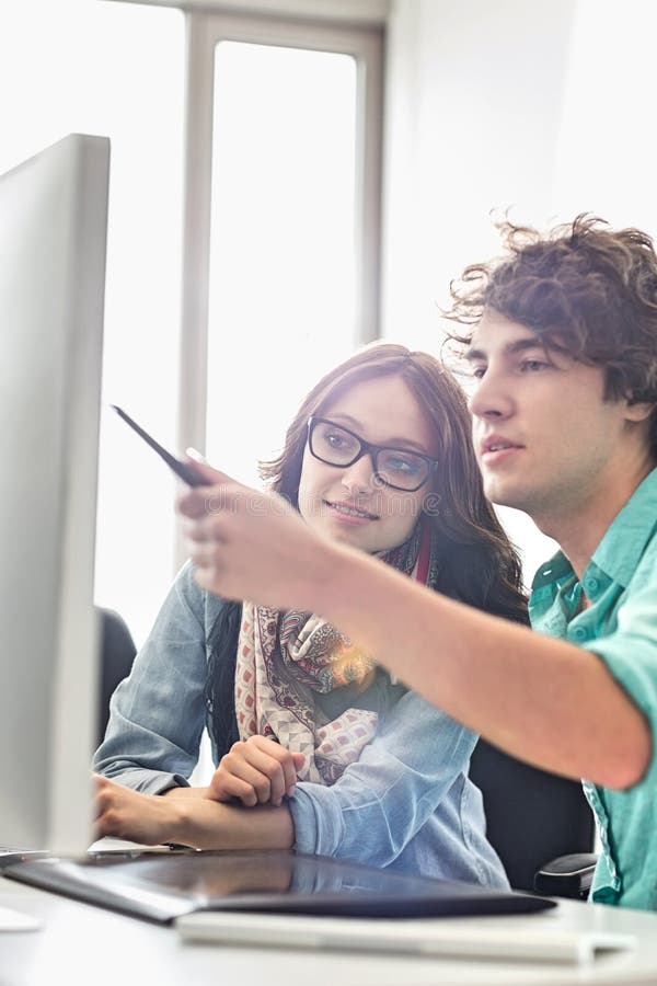 Creative Business Colleagues Discussing Over Desktop Computer in Office ...