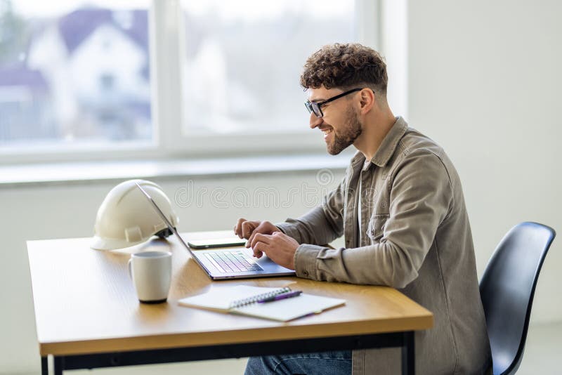 Creative Business Man Working on a Laptop in an Open Plan Office Stock ...