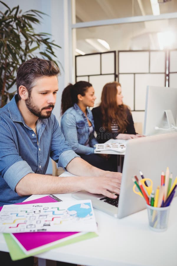 Creative Business People Using Technologies at Desk Stock Image - Image ...