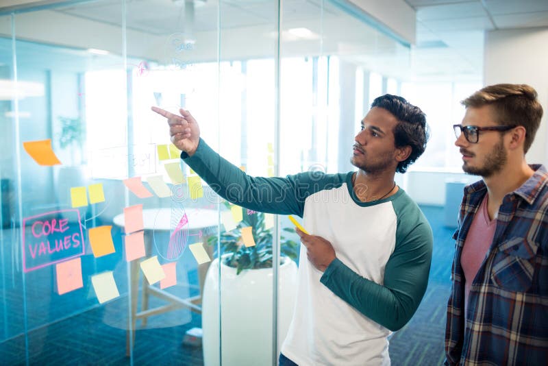 Creative Business Team Looking at Sticky Notes and Discussing Stock ...