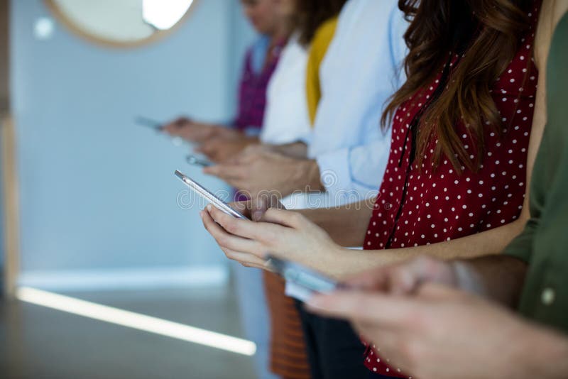 Creative Business Team Using Mobile Phone in Office Stock Photo - Image ...